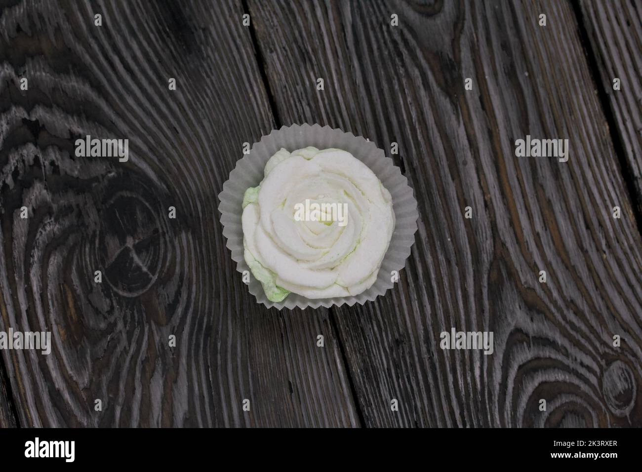 Homemade zephyr in a paper mold. On black pine boards. Taken from above ...
