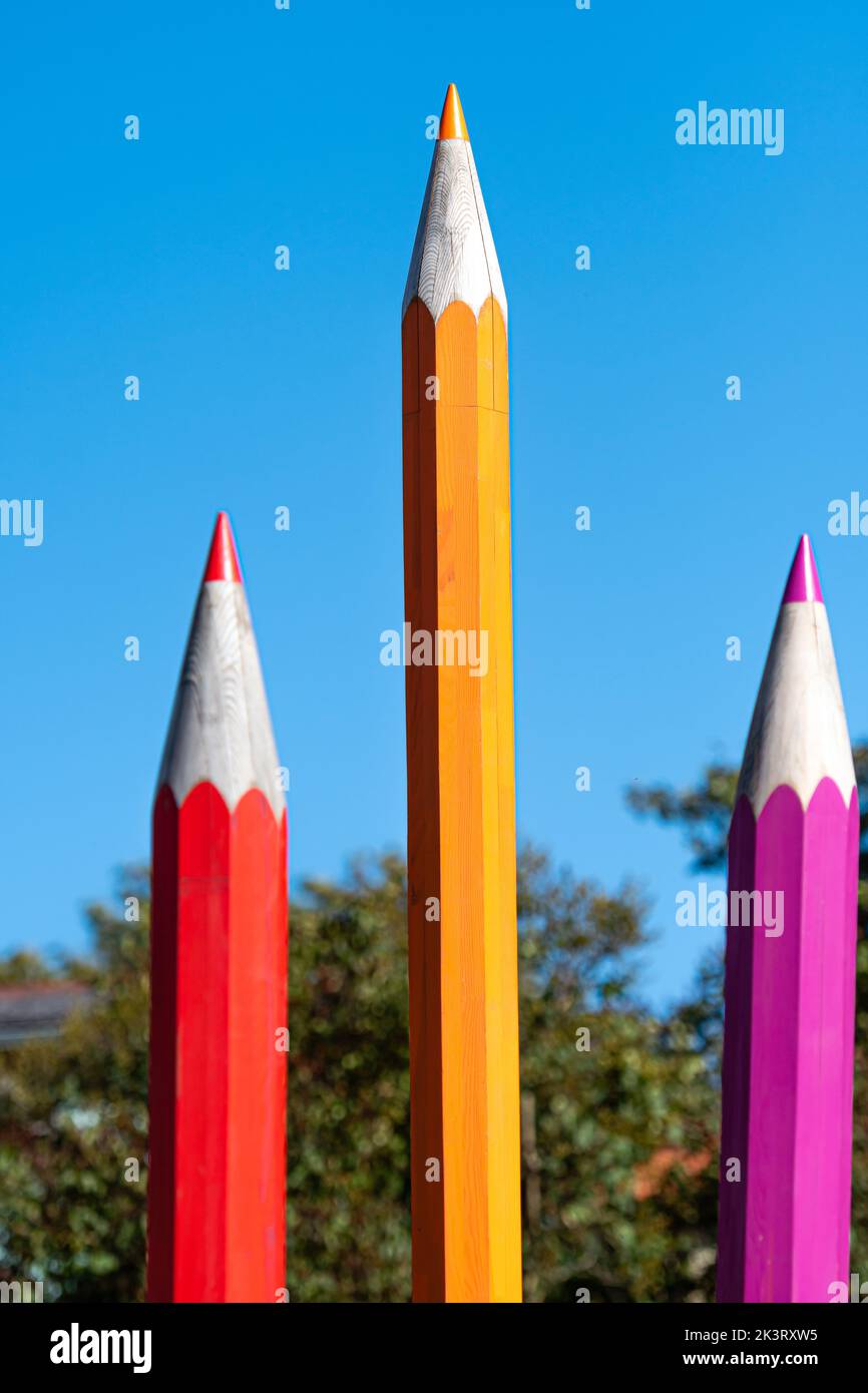 large decorative colored wooden pencils on defocused background, back ...