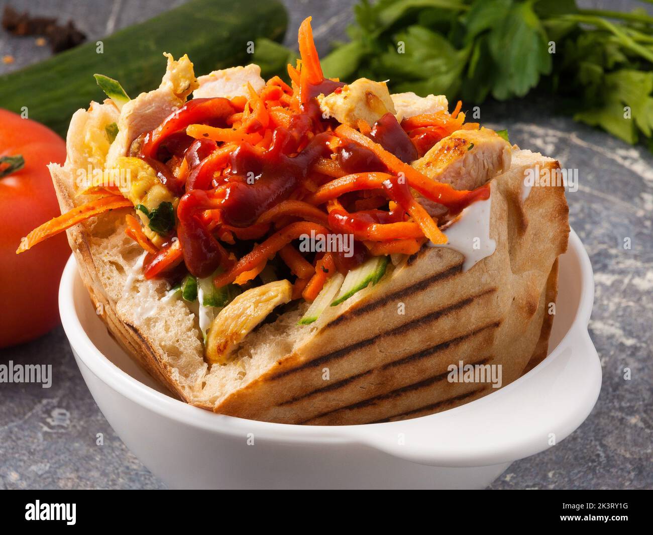 tasty Shawarma with chicken in a pit with carrots and ketchup. close up ...