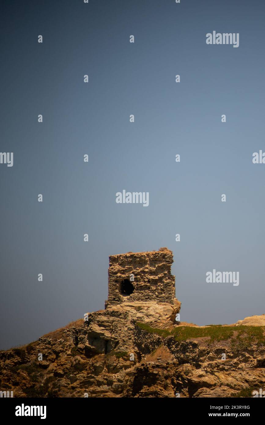A vertical of an old rock with a blue sky Stock Photo - Alamy