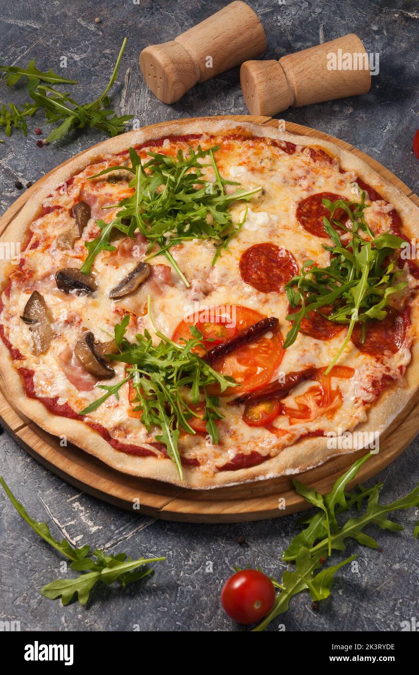 tasty assorted pizza with different fillings: salami, tomatoes ...