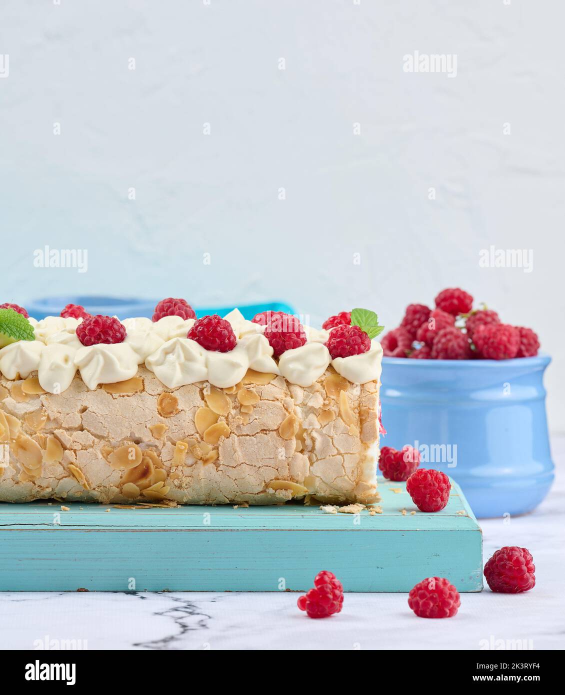 Baked meringue roll with cream and fresh red raspberry, white ...