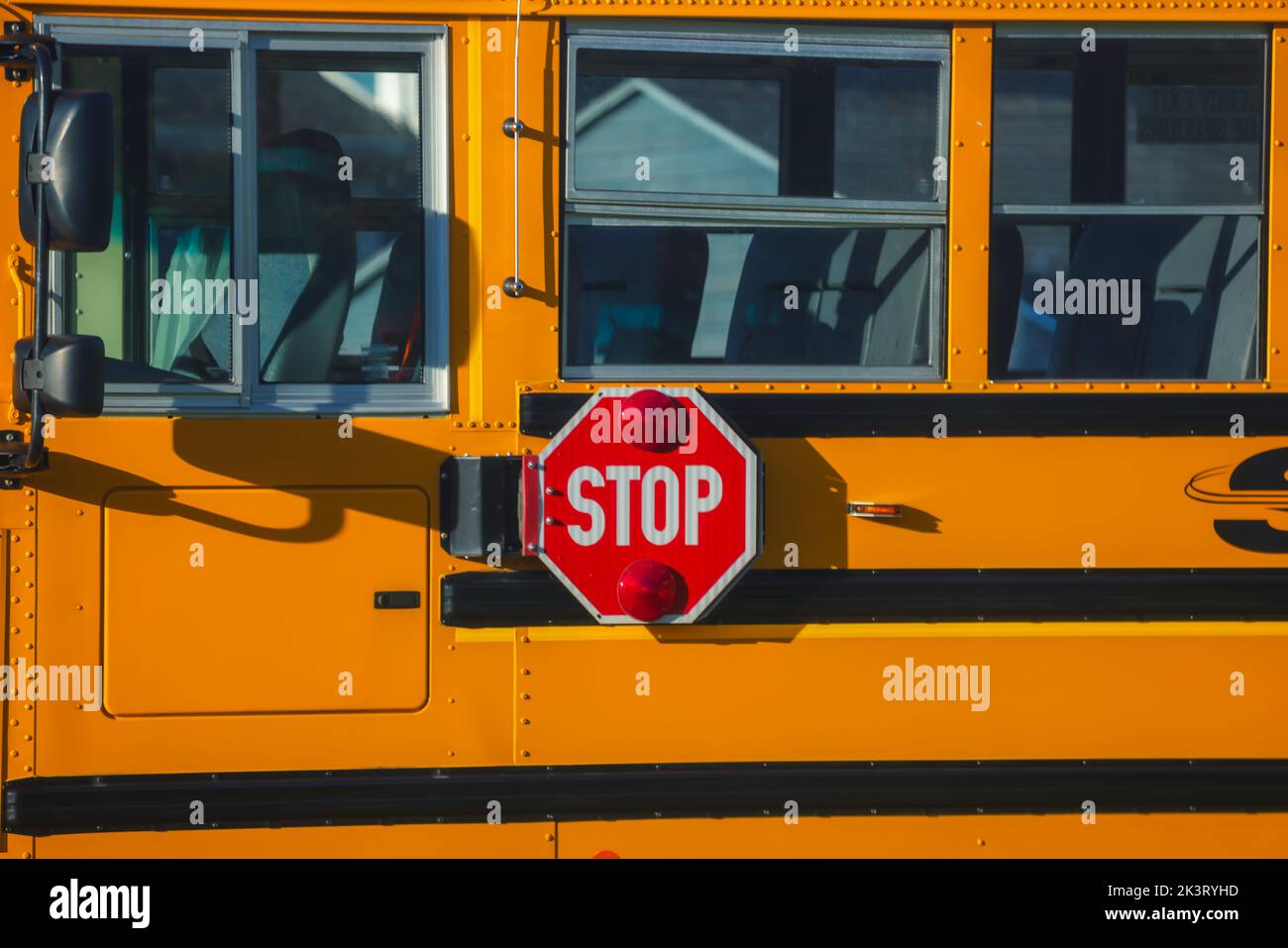 Close up of an octagon shaped red stop sign with signal lights on a ...