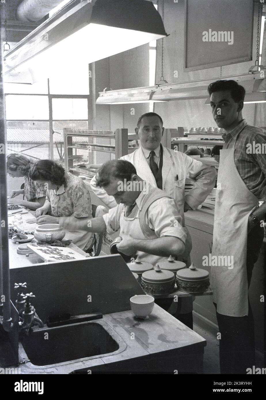 1950s, historical, workers putting decorative pieces onto pottery at ...