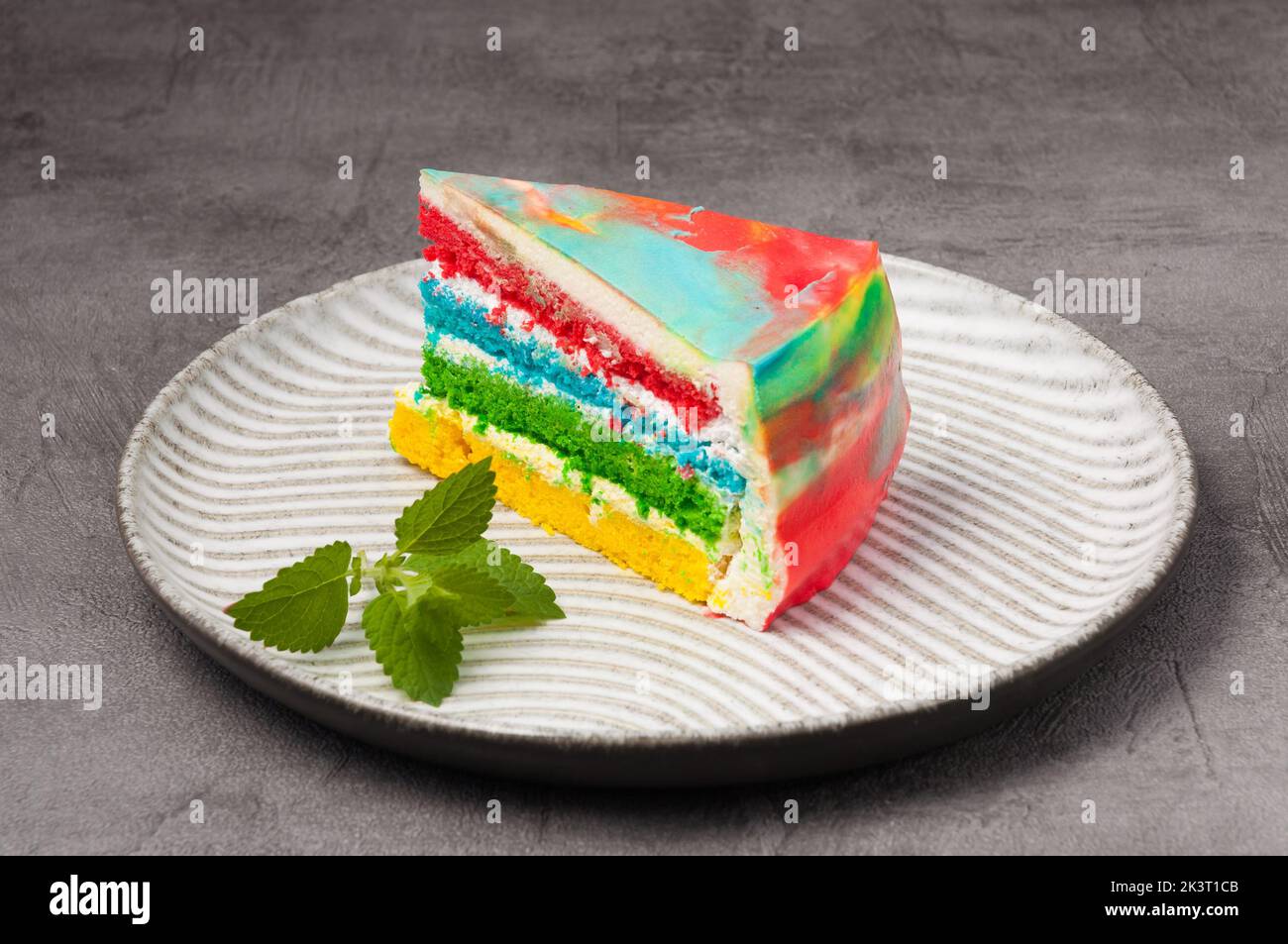 sweet piece of rainbow sponge cake with cream Stock Photo - Alamy
