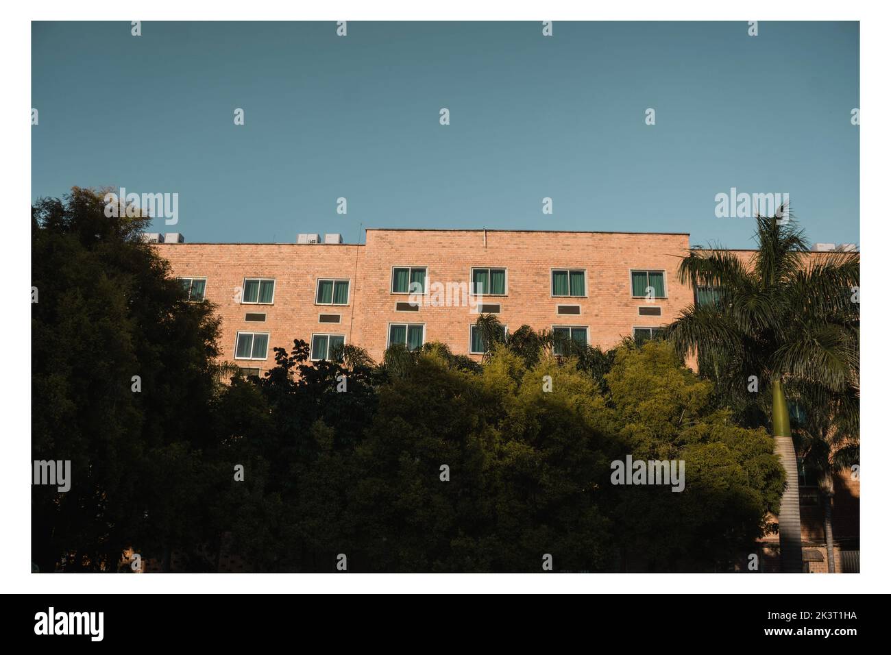 partial view of a building in the morning with the sun shinning on it ...