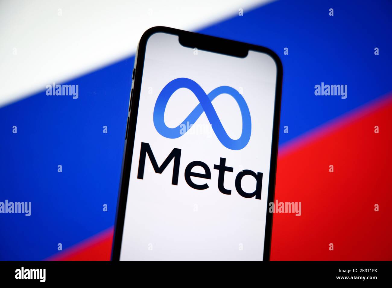The Meta logo is seen on a mobile phone with the Russian flag in the ...