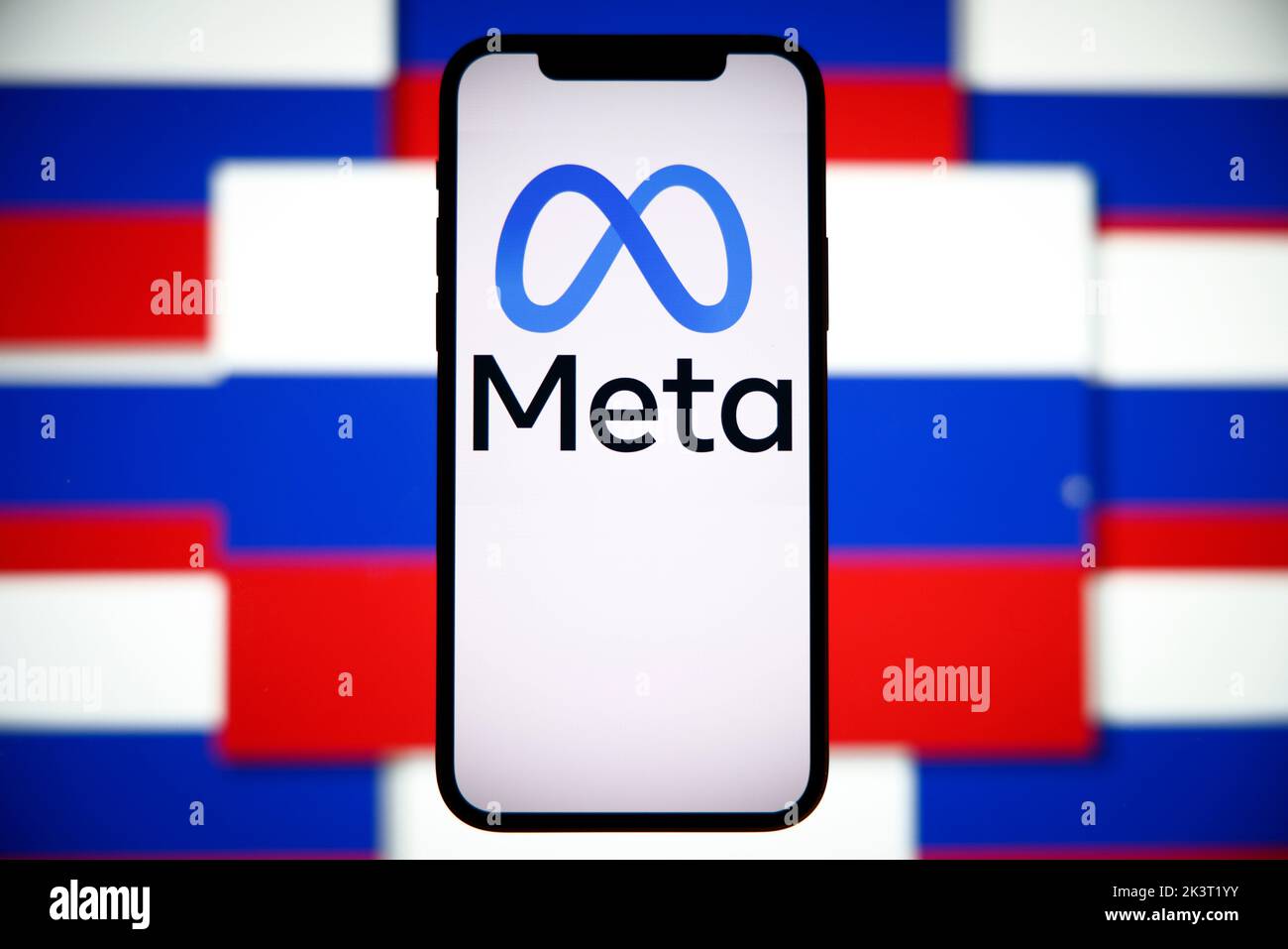 The Meta logo is seen on a mobile phone with the Russian flag in the ...