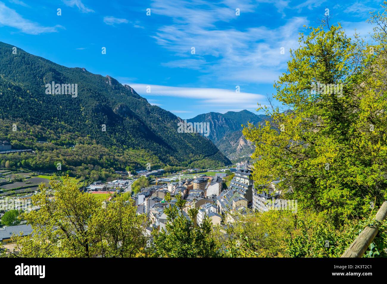 An aerial view of the town of Andorra la Vella under a bright sky in ...