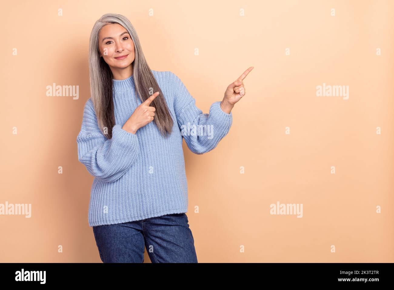 Photo of sweet cute woman pensioner dressed blue pullover pointing ...