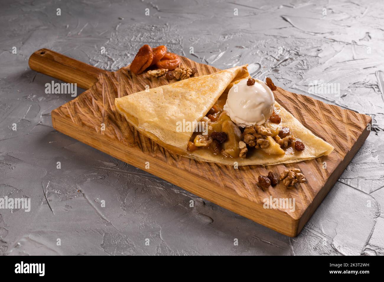 Crepes stuffed with fruit and nuts. Served with ice cream ball. Thin ...