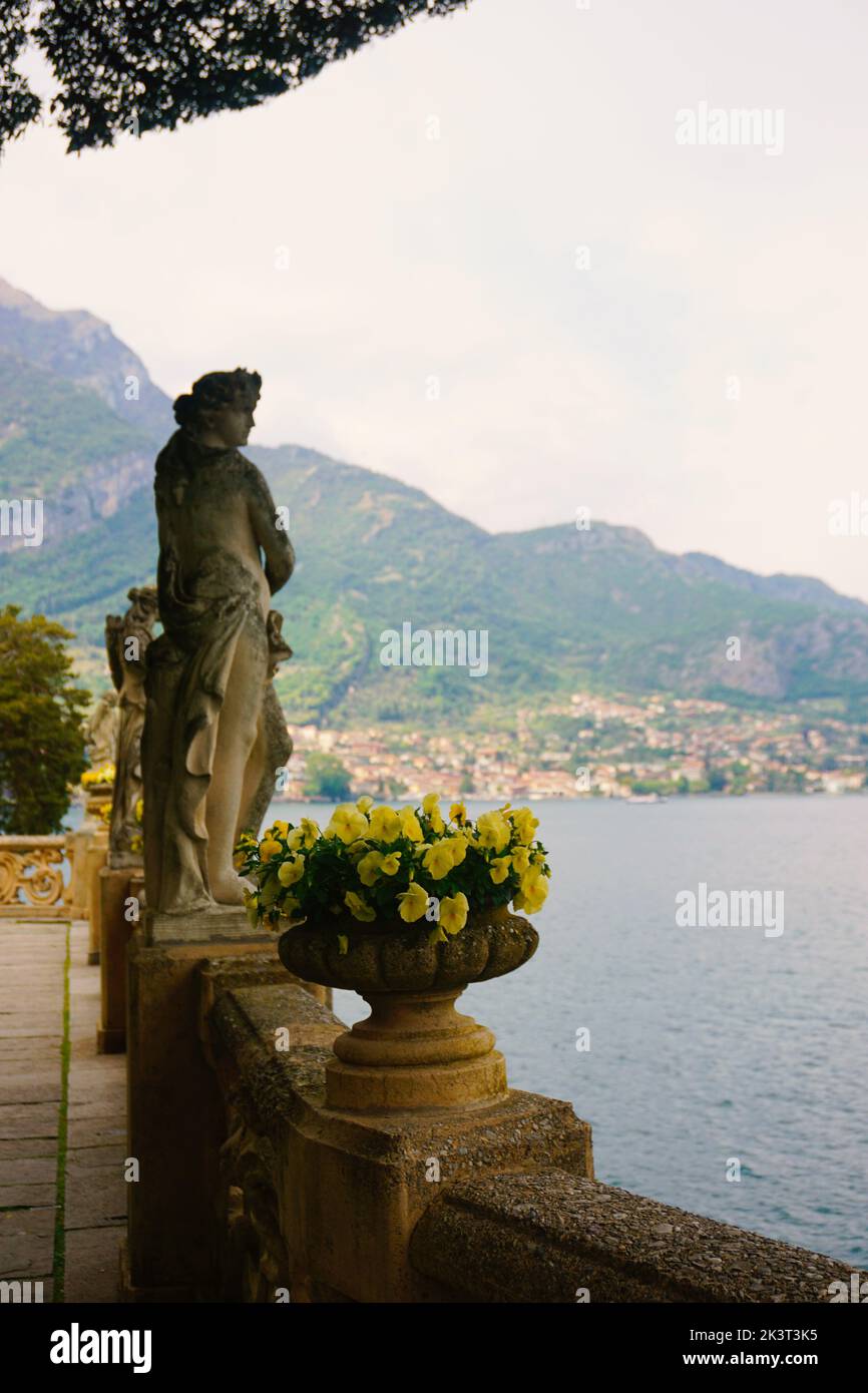 A vertical shot of beautiful sculptures on the shore of the lake Como ...