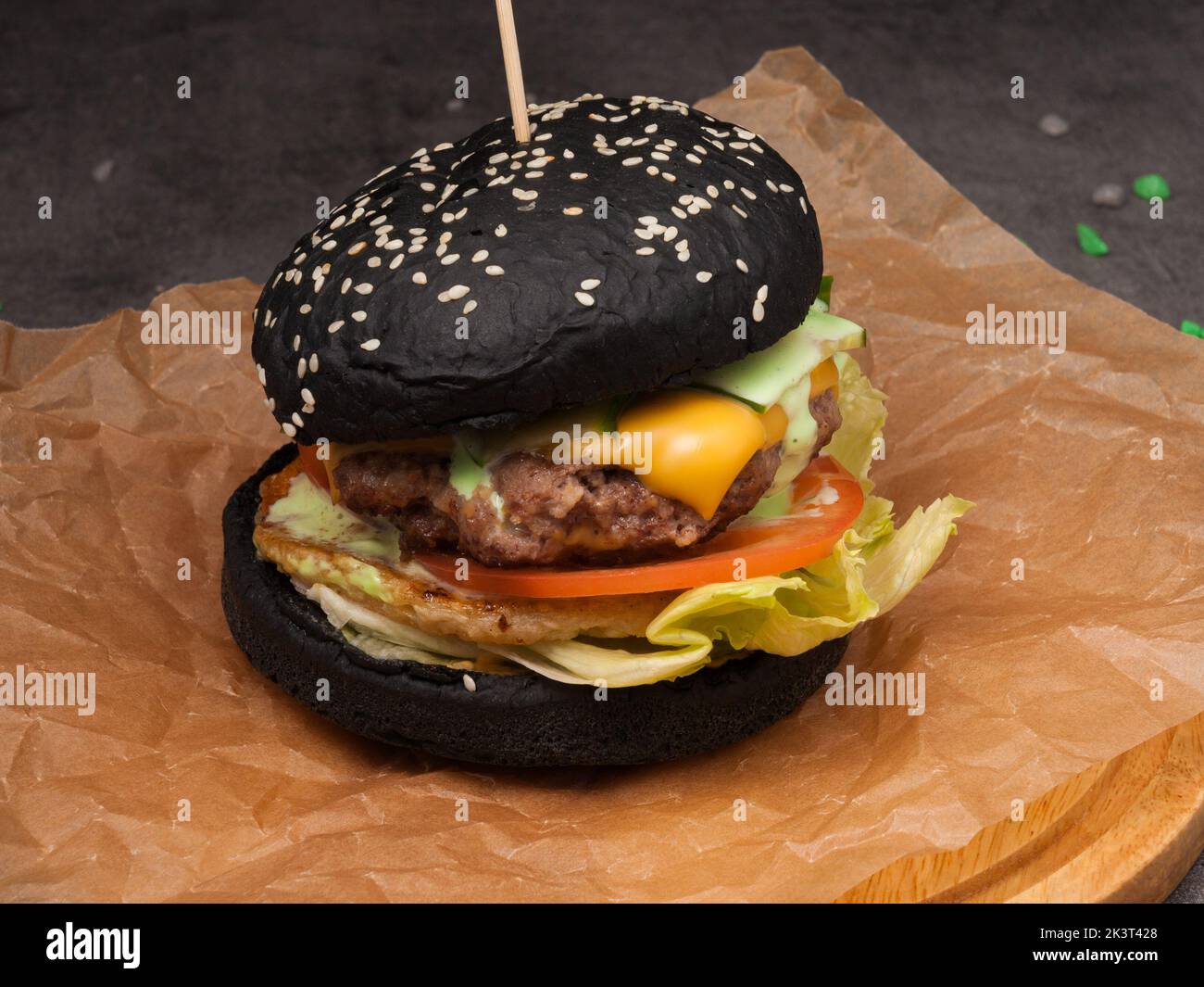 tatsy black burger with chicken and beef, cheddar cheese, tomato ...