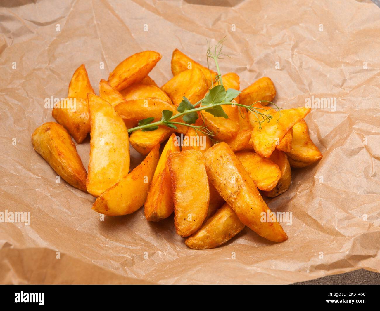 tatsy potato slices in rustic style on craft paper Stock Photo - Alamy