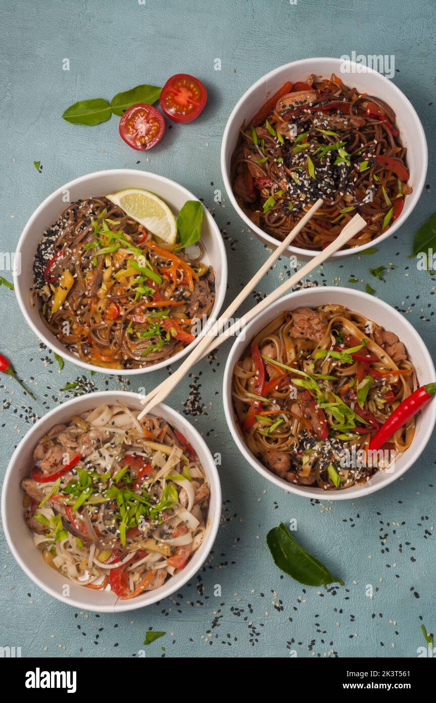assorted tasty Asian noodles in craft bowls. concept: food delivery ...
