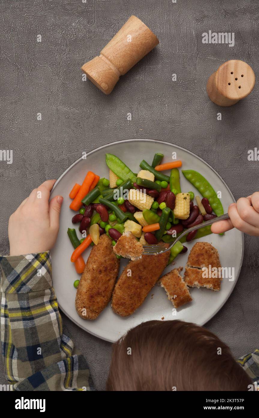 Child eating vegetarian burger hi-res stock photography and images - Alamy