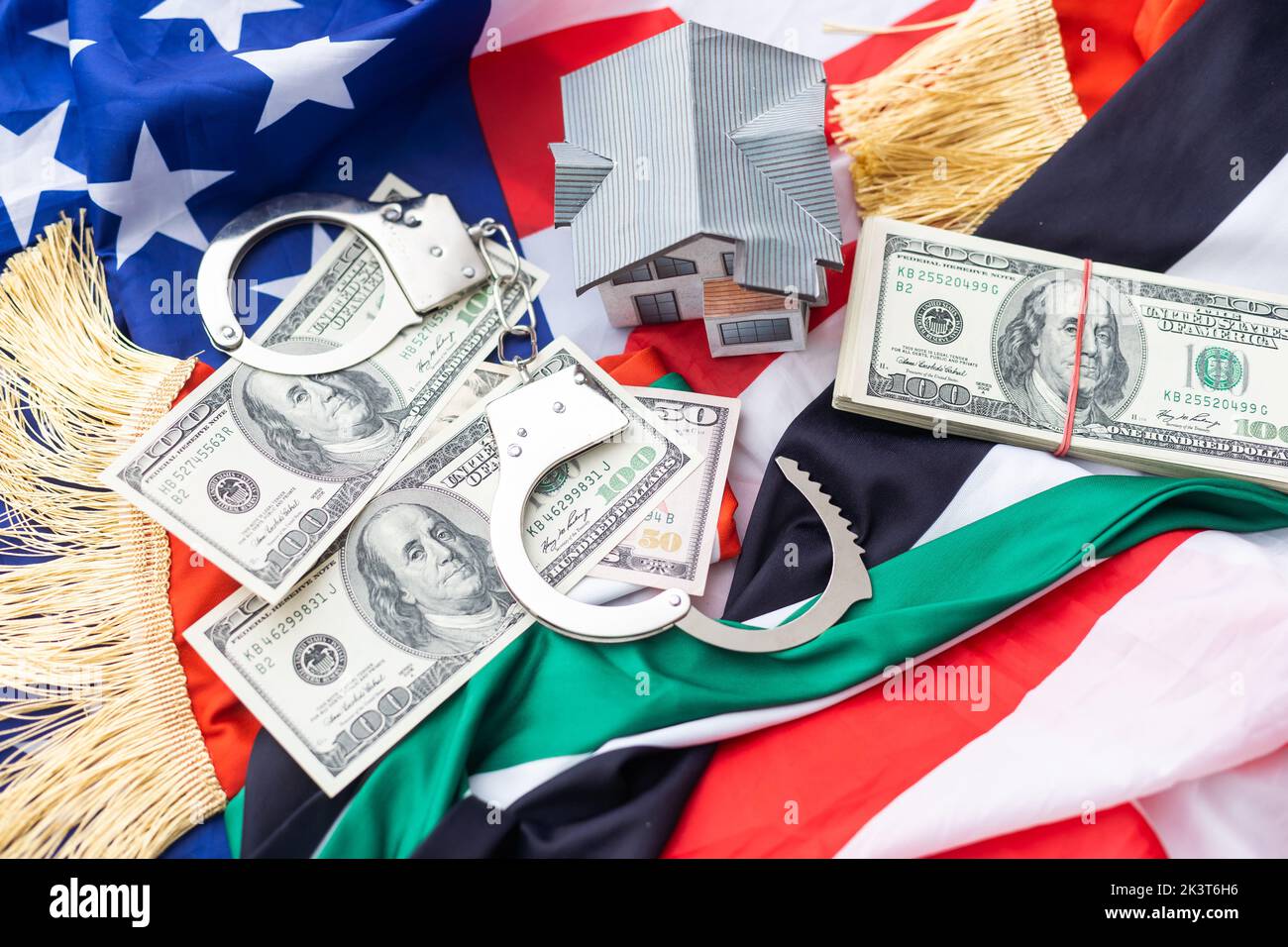 metal handcuff, american dollars cash over flag of USA and UAE flags ...