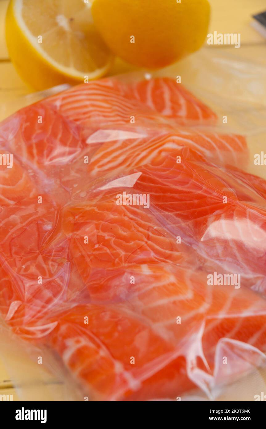 tasty salmon fillet in a vacuum package with lemon Stock Photo - Alamy