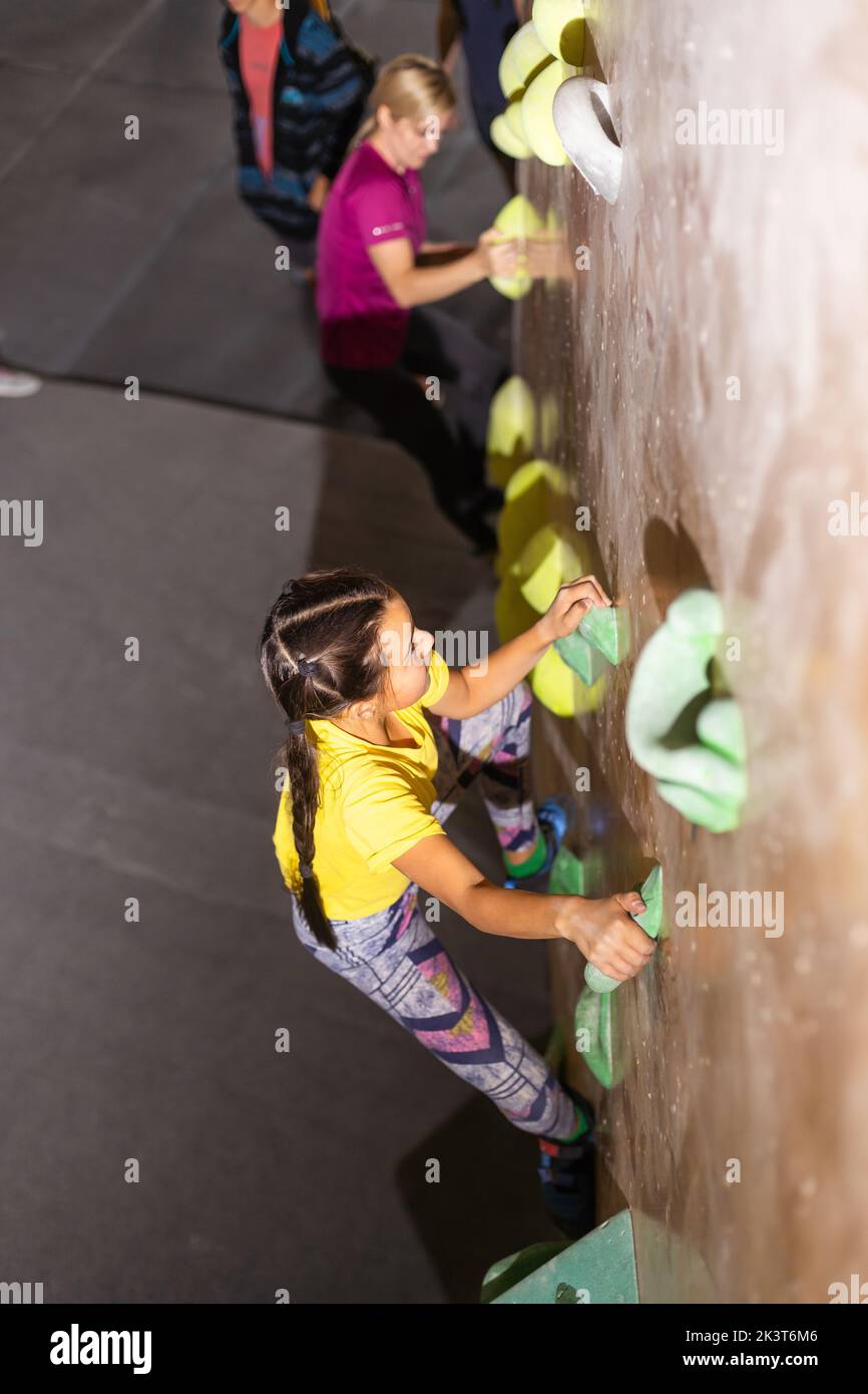 mother and daughter climb on the climbing wall. Family sport, healthy ...