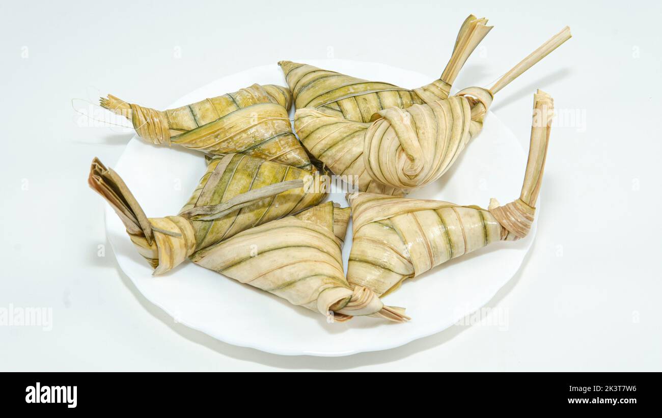 Famous Malay glutinous rice cakes, known as "KETUPAT PALAS" on white ...