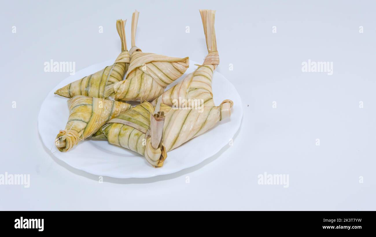 Famous Malay glutinous rice cakes, known as "KETUPAT PALAS" on white ...