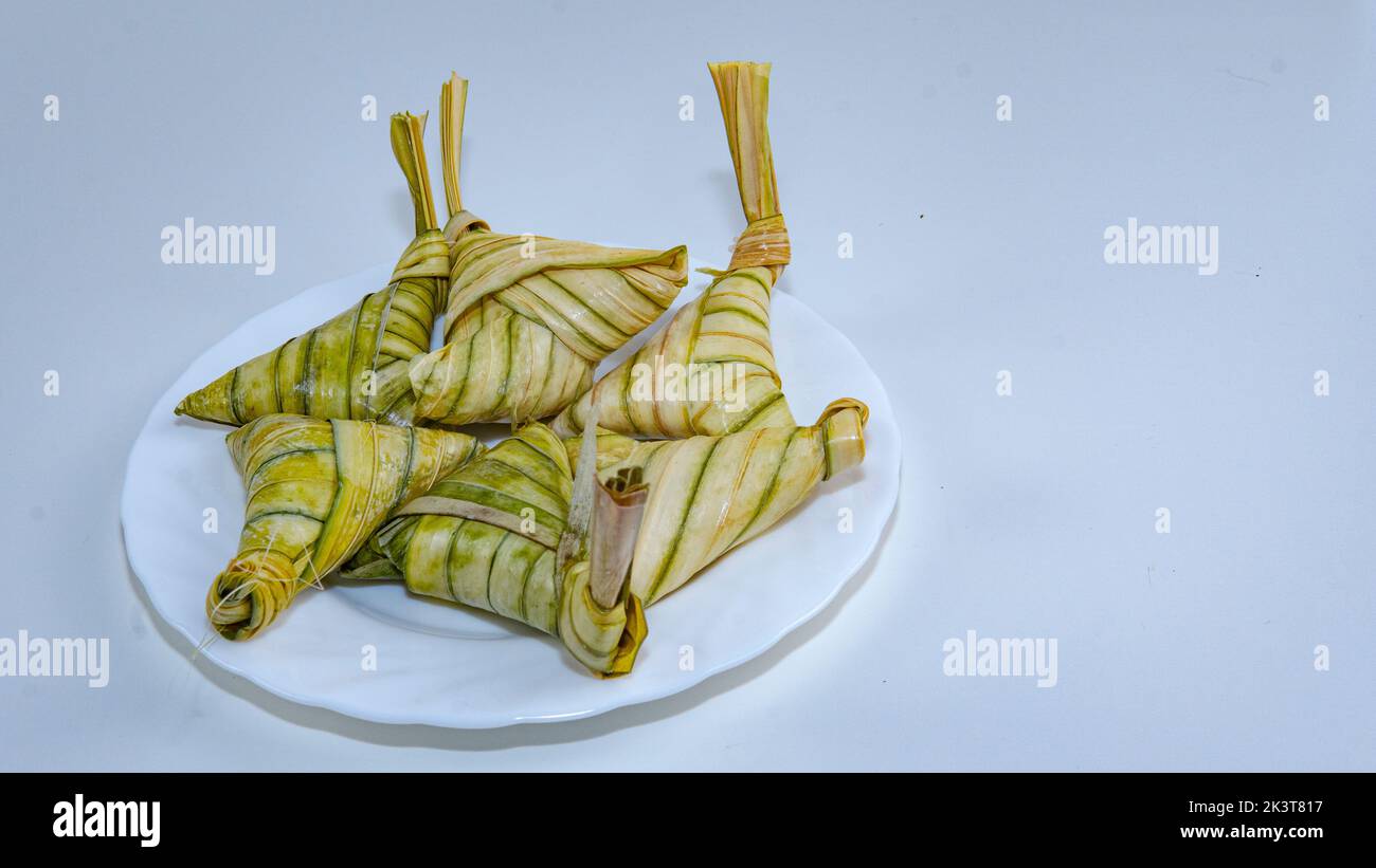 Famous Malay glutinous rice cakes, known as "KETUPAT PALAS" on white ...