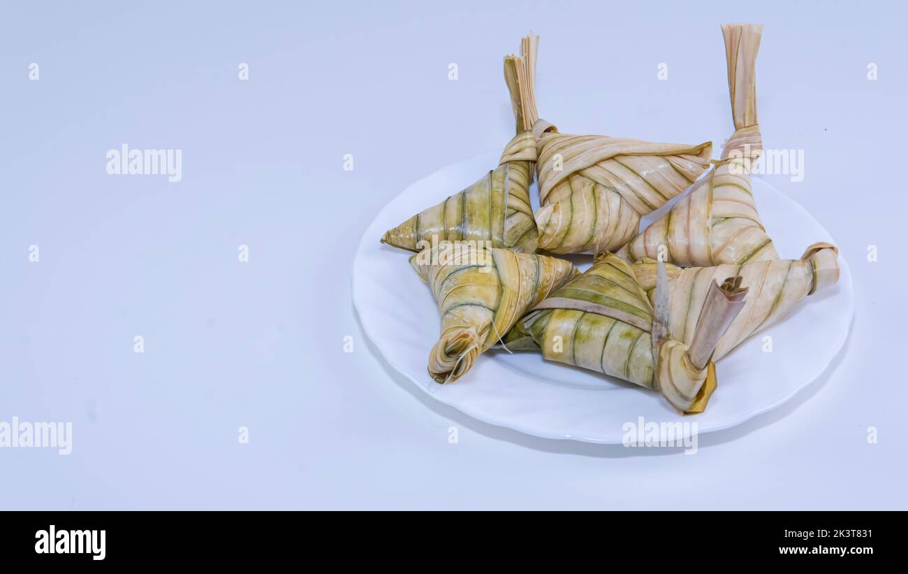 Famous Malay glutinous rice cakes, known as "KETUPAT PALAS" on white ...