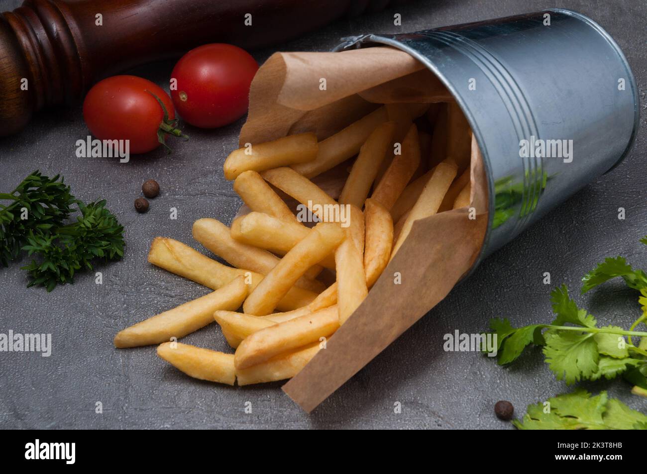 tasty french fries in a metal bucket on a gray background Stock Photo ...