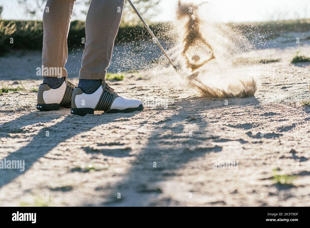 Ground level side view of crop anonymous male athlete in golf shoes ...