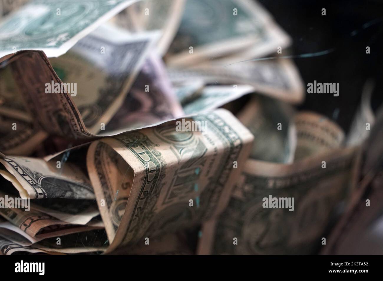 many dollar check paper inside transparent tip box Stock Photo - Alamy