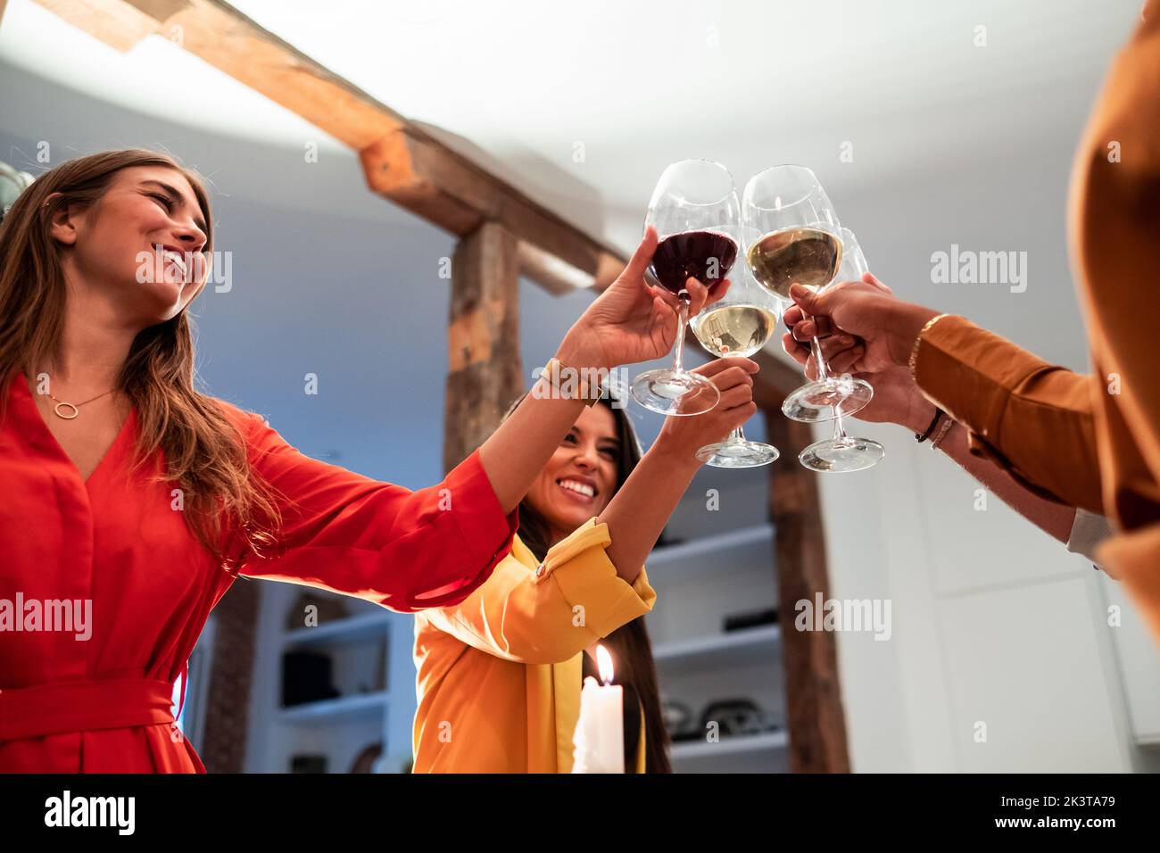 From bellow side view of cheerful diverse friends celebrating and ...