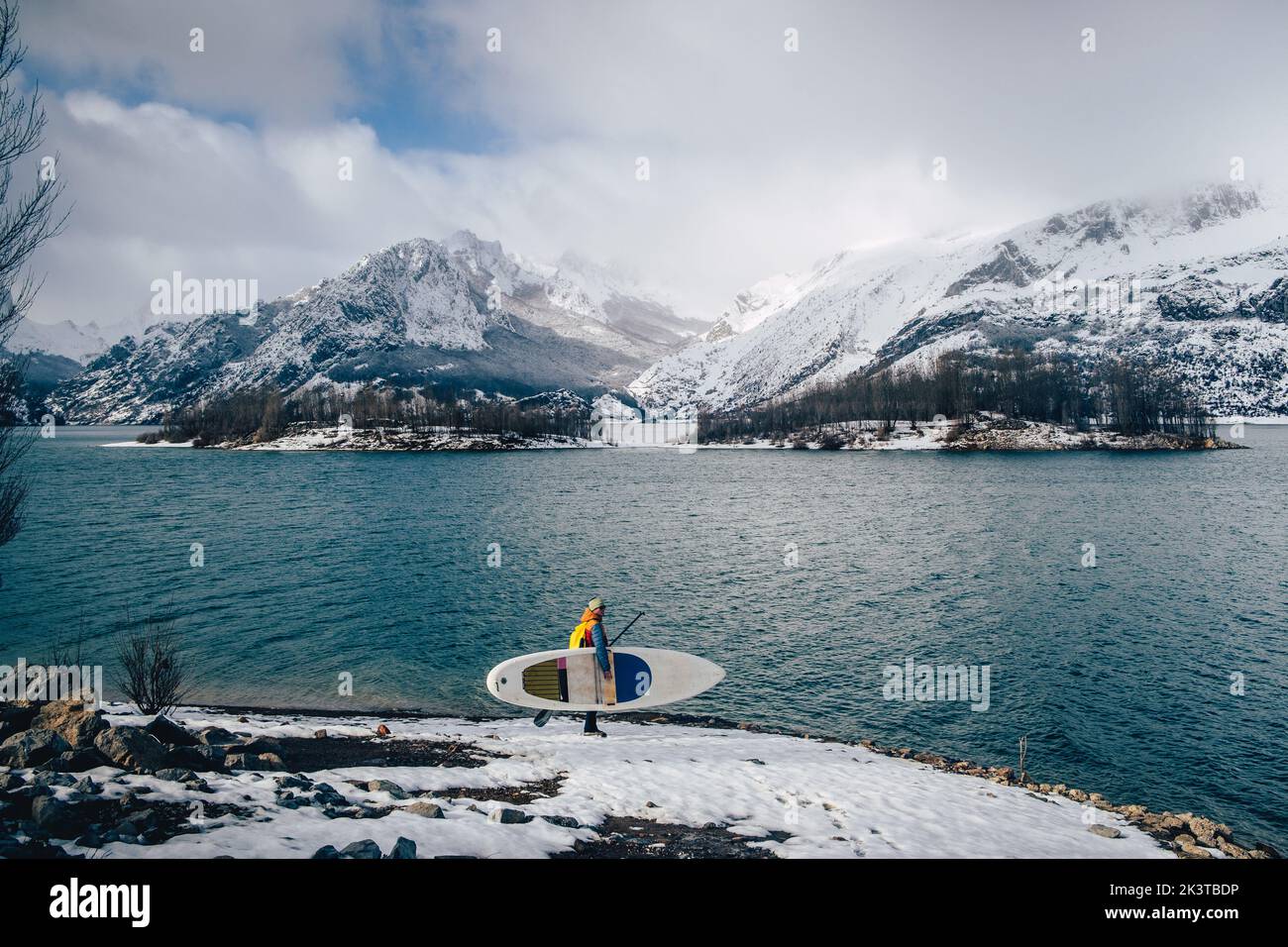 Side view of tourist bringing sup on coast and picturesque view of ...