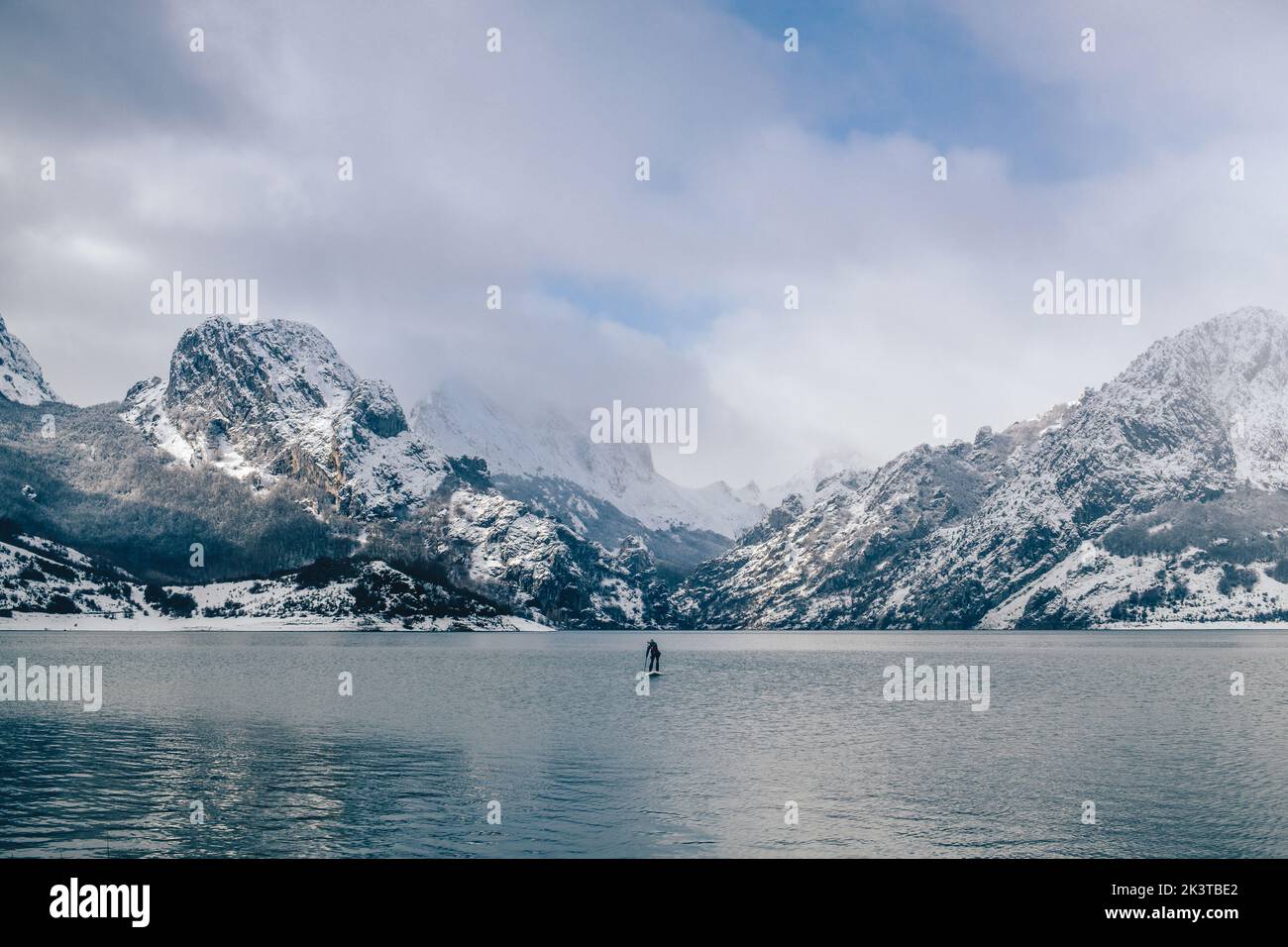 Tourist floating on sup between water surface and picturesque view of ...