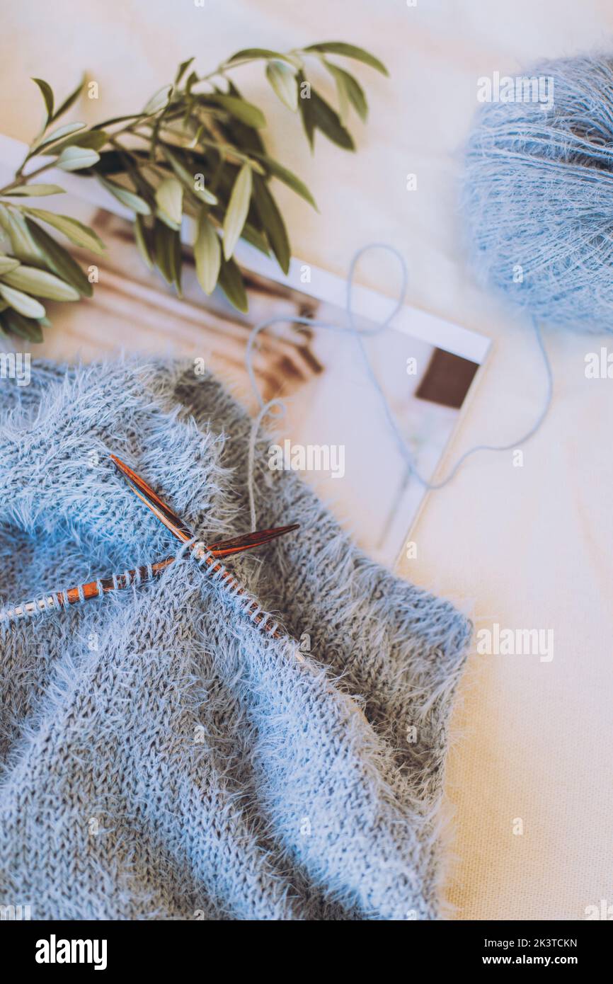 Hand knitting with needles and grey blue yarn ball on white background ...