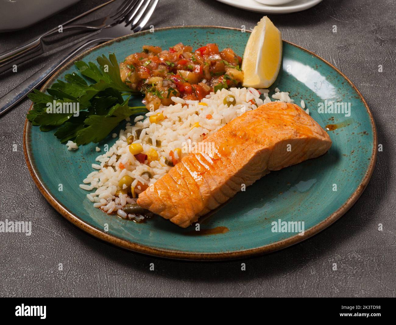 tasty grilled salmon, rice with vegetables and vegetable salad Stock ...