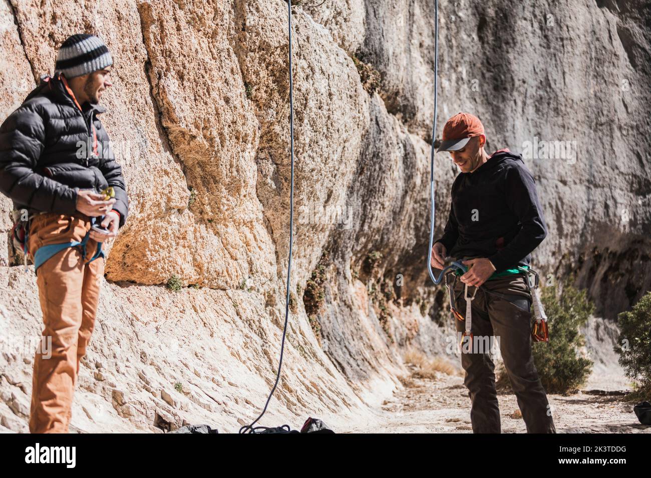 Two climbers preparing rope before climbing Stock Photo - Alamy