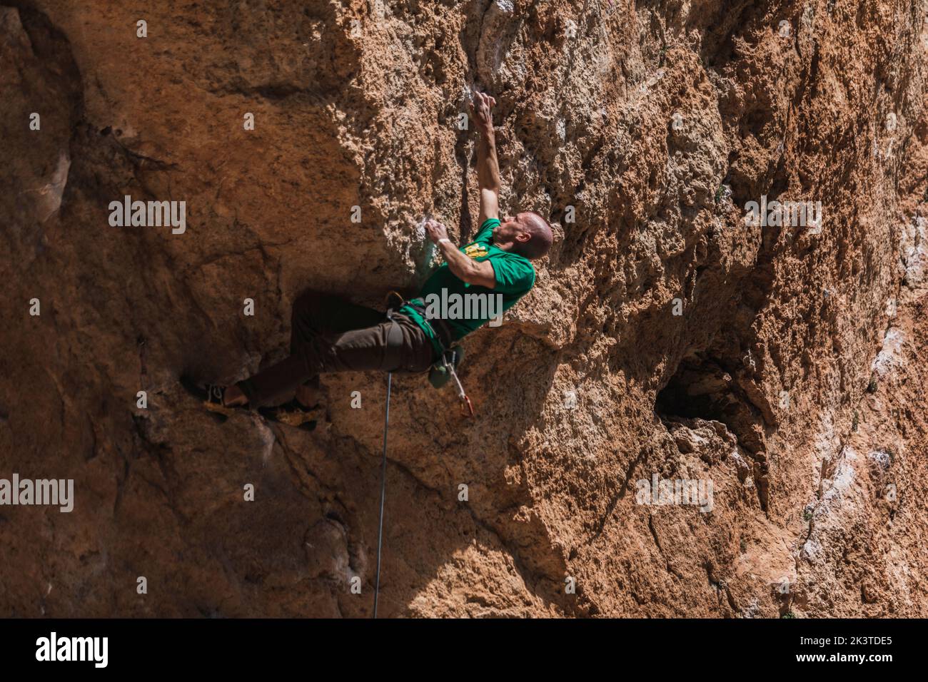 climber hanging on rope on rough cliff Stock Photo - Alamy