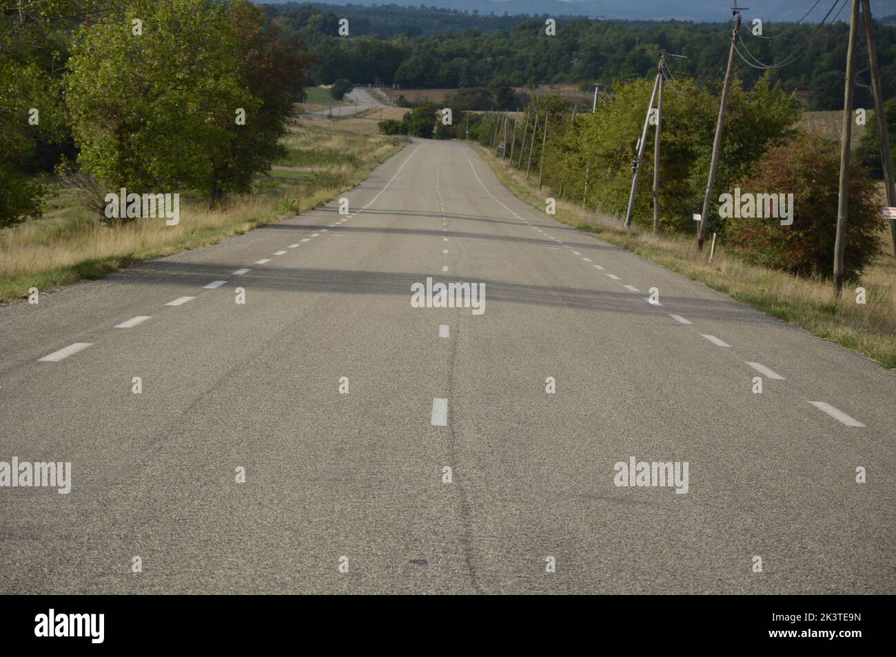 Long asphalt road in the countryside, France Stock Photo - Alamy