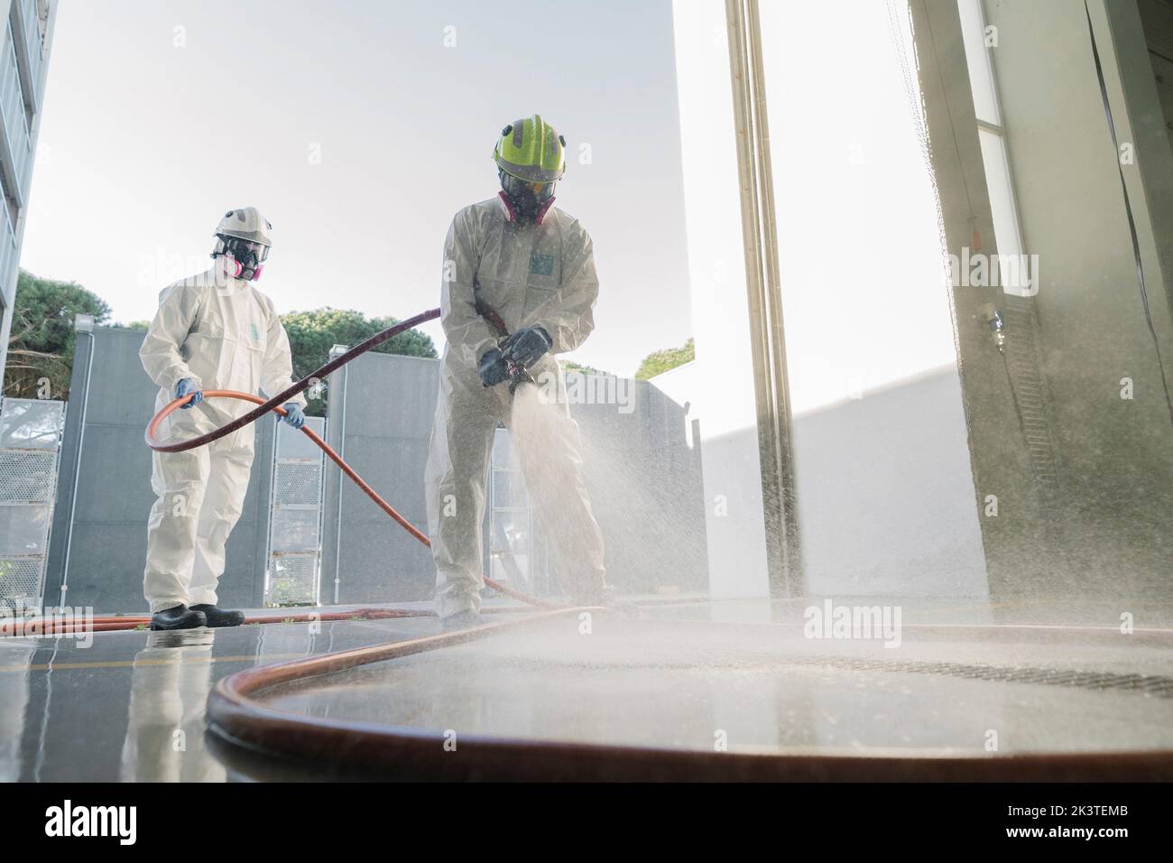 Two firefighters disinfecting the interior of a building Stock Photo ...