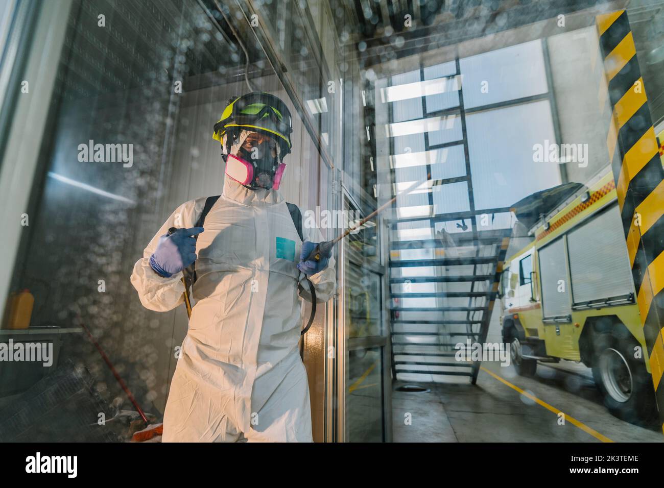 Firefighter disinfecting the facilities of a fire station Stock Photo ...