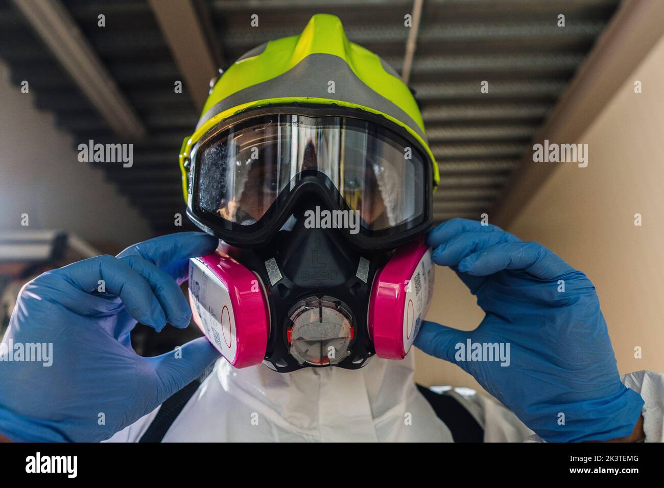 Firefighter putting on mask to disinfect a building Stock Photo - Alamy