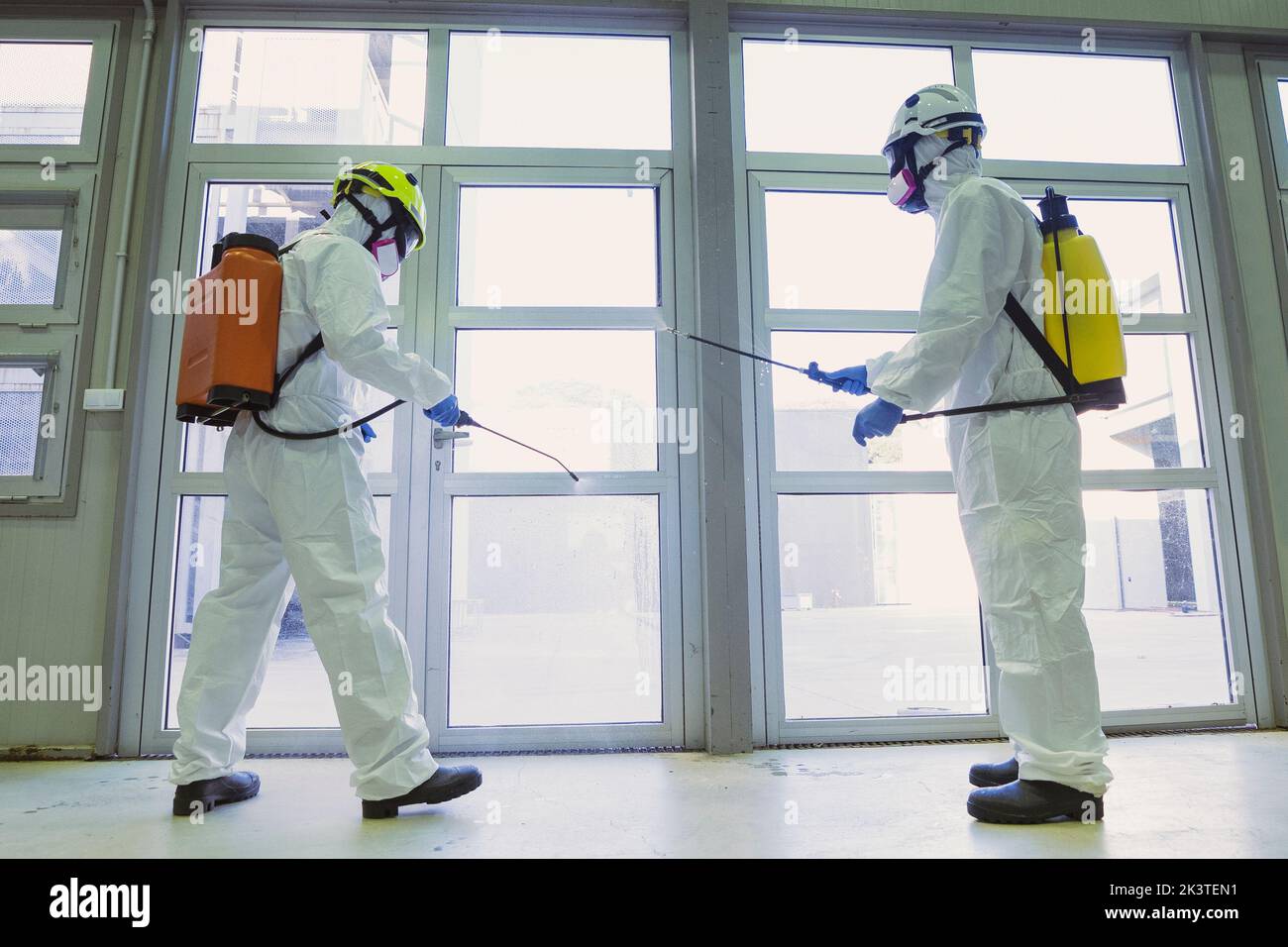 Two firefighters disinfecting the interior of a building Stock Photo ...