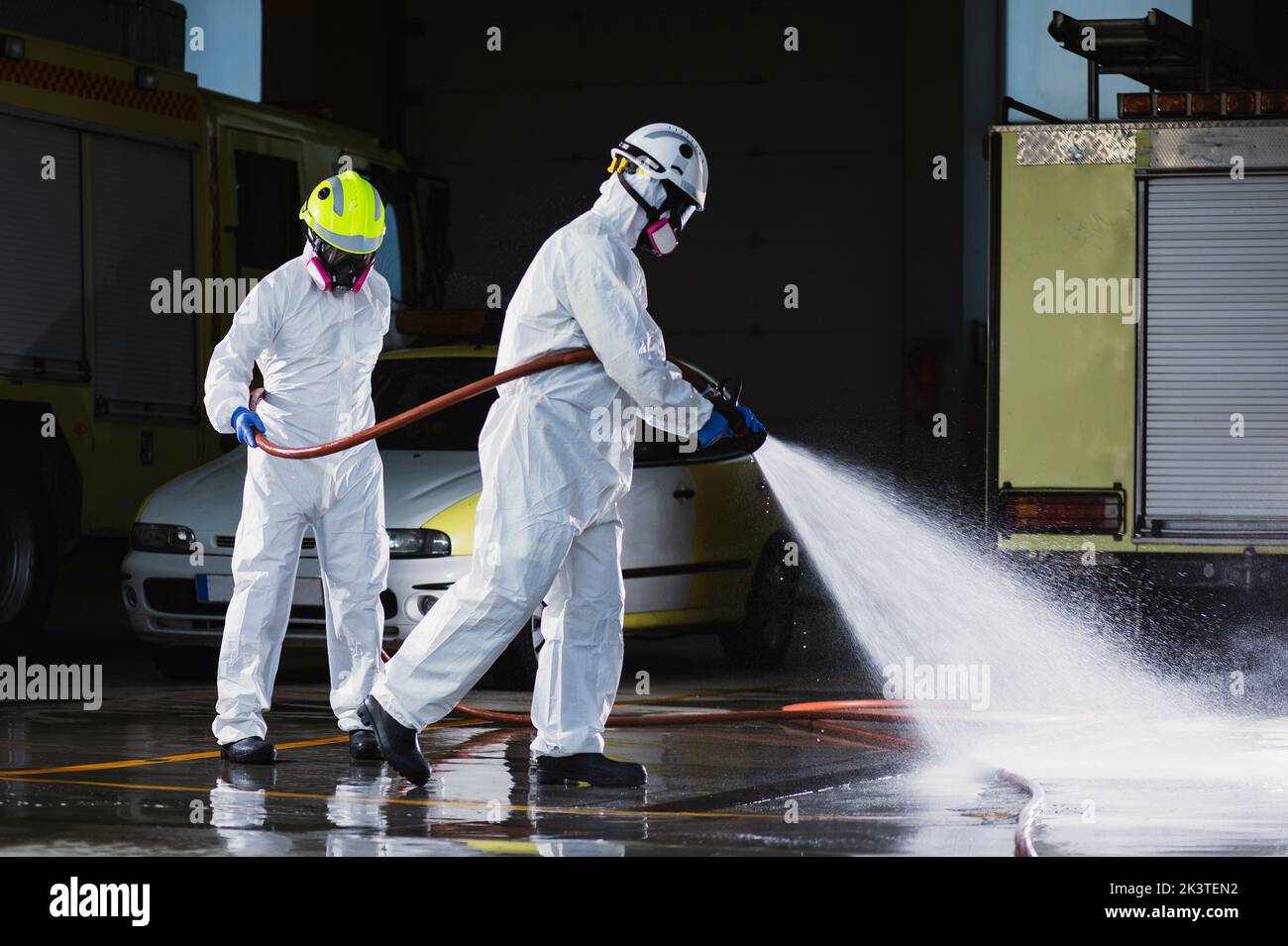 Two firefighters disinfecting the interior of a building Stock Photo ...