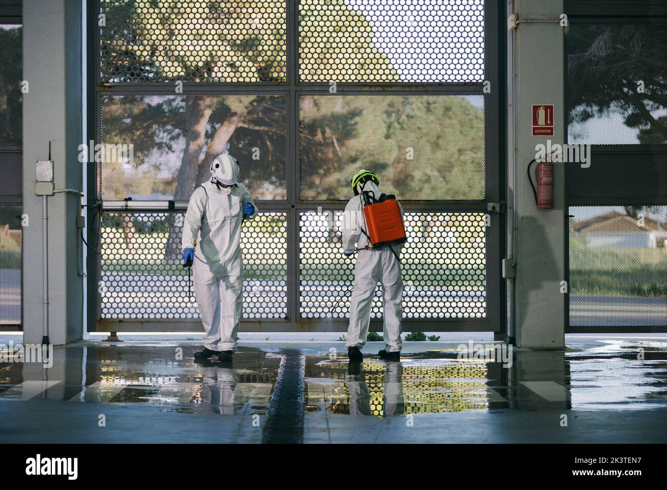 Two firefighters disinfecting the interior of a building Stock Photo ...