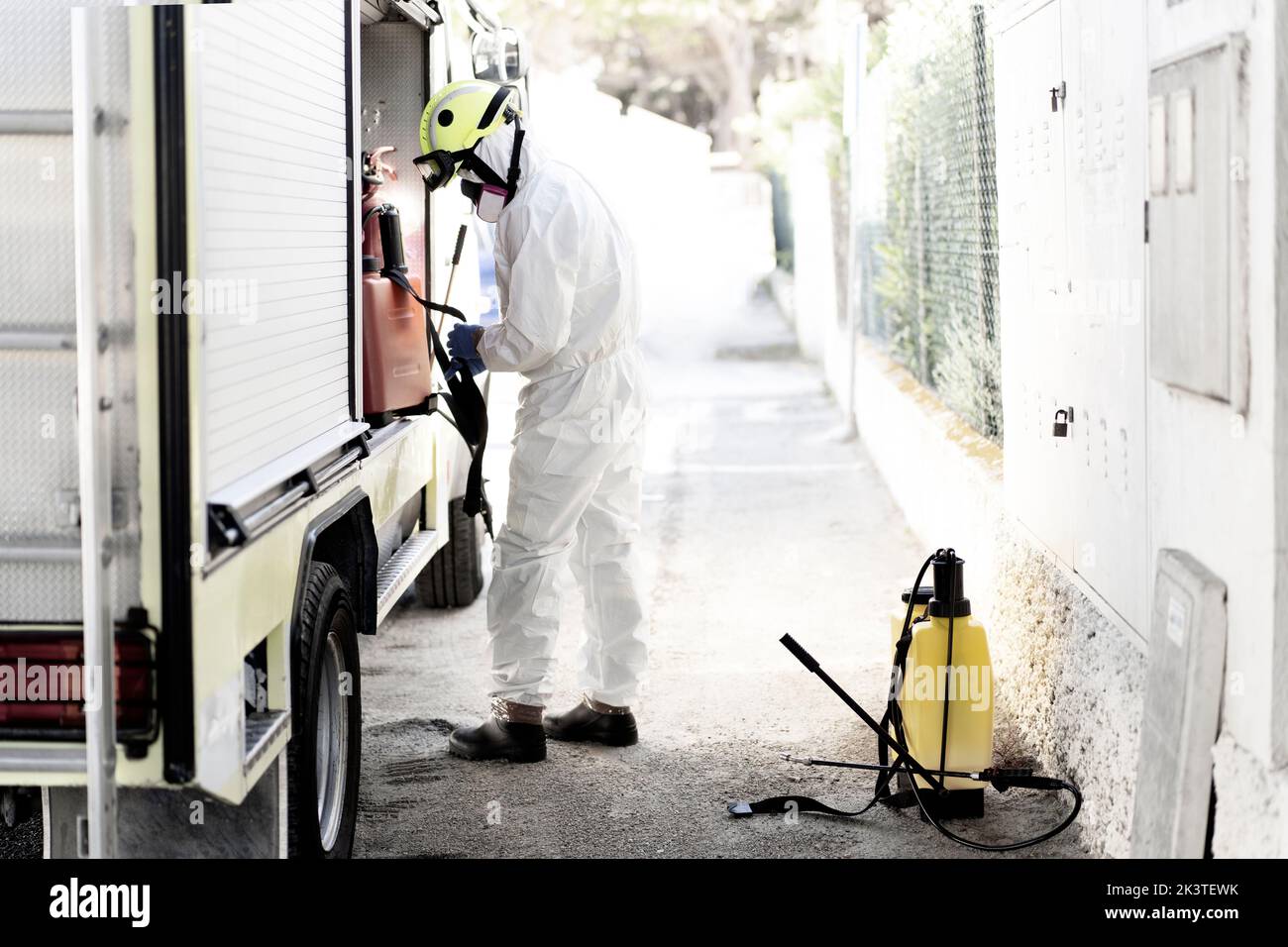 Firefighter picking up materials to disinfect a building Stock Photo ...