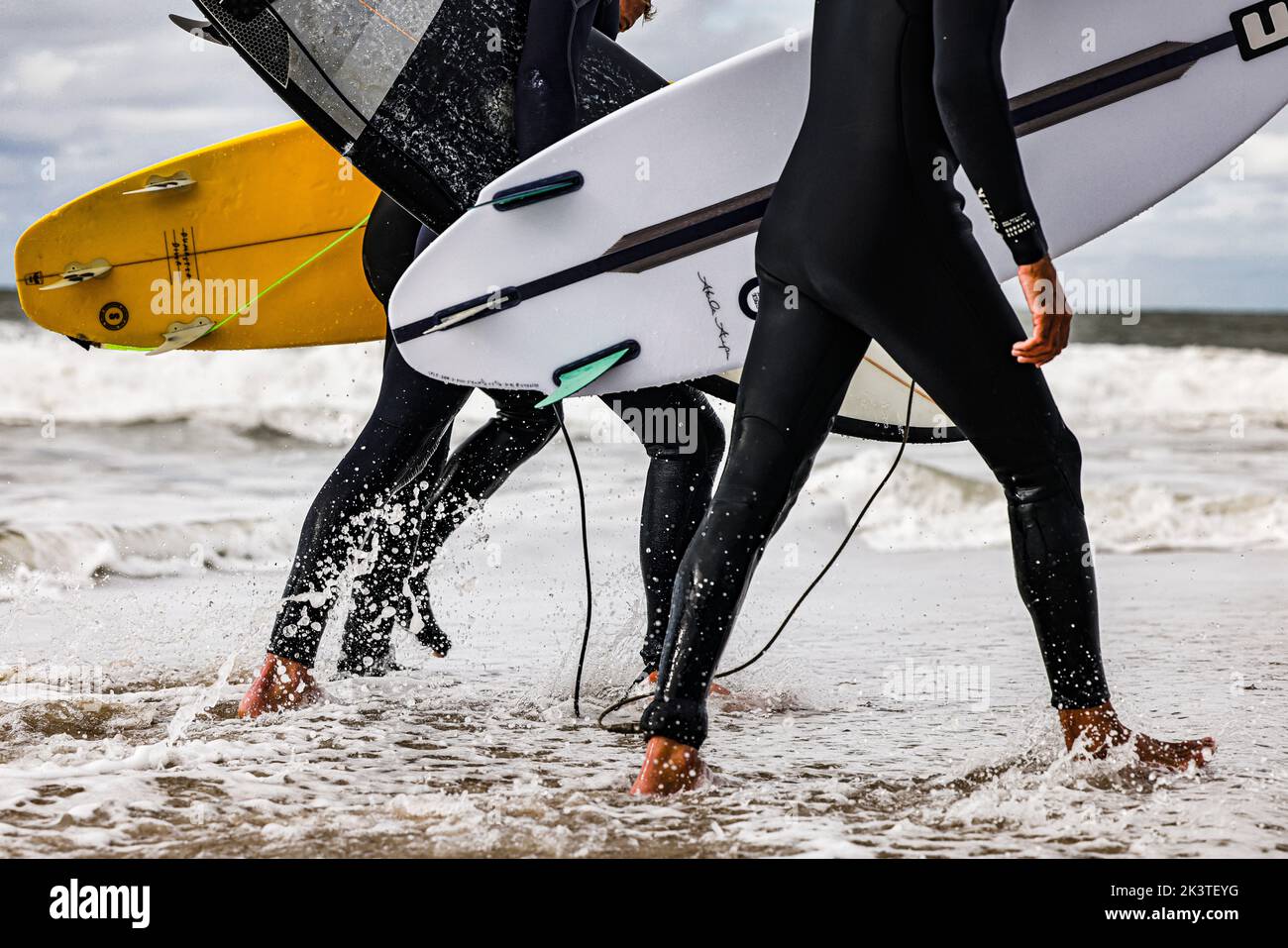 Westerland, Germany. 28th Sep, 2022. Surfers walk at the beach on the ...