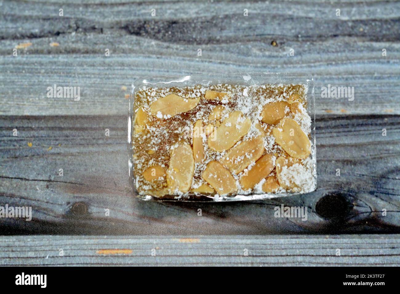 Egyptian taffy with peanuts and coconuts, an Eastern candy made as a ...