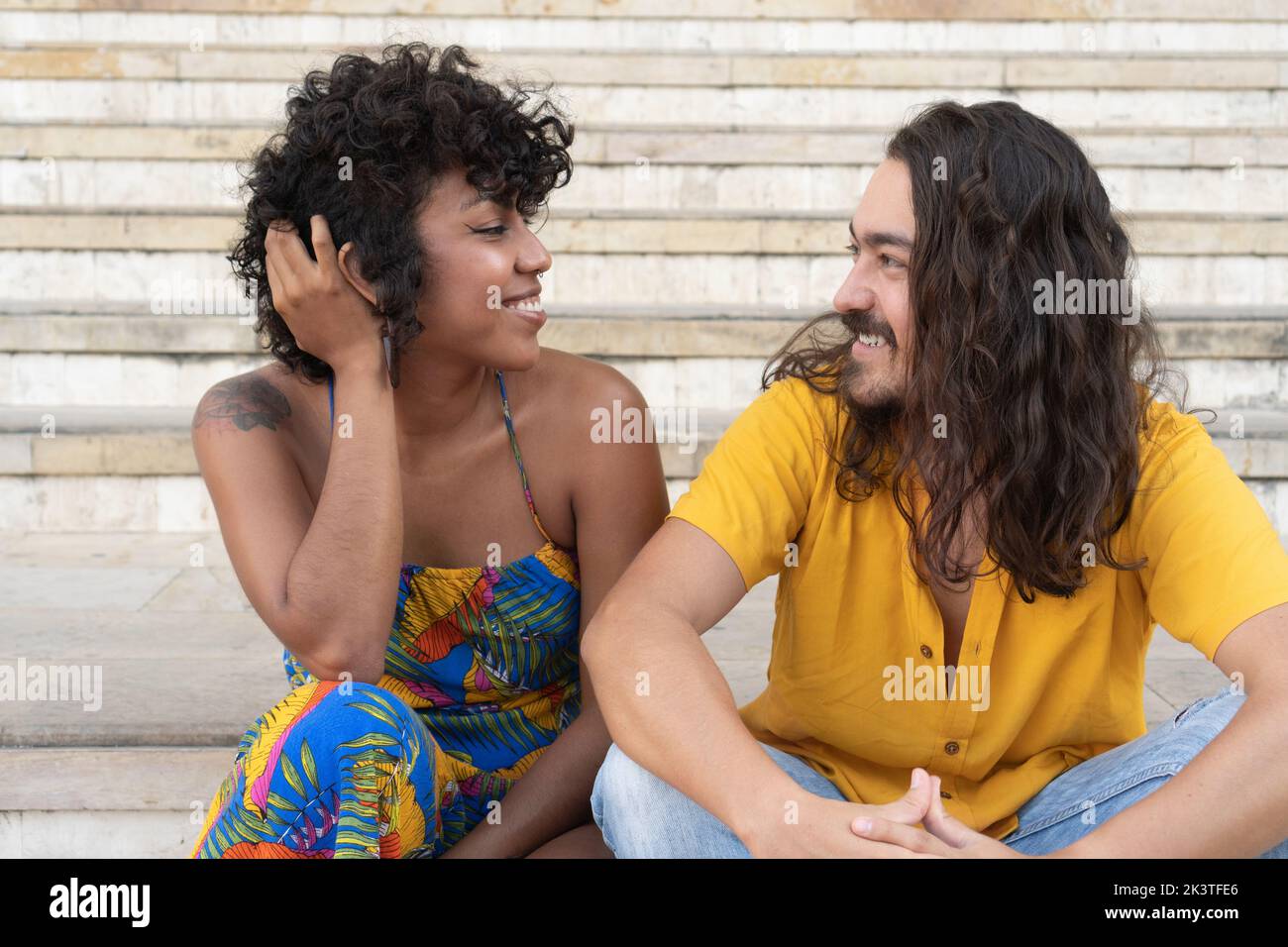 Cheerful ethnic couple of girlfriend with curly hairstyle and boyfriend ...