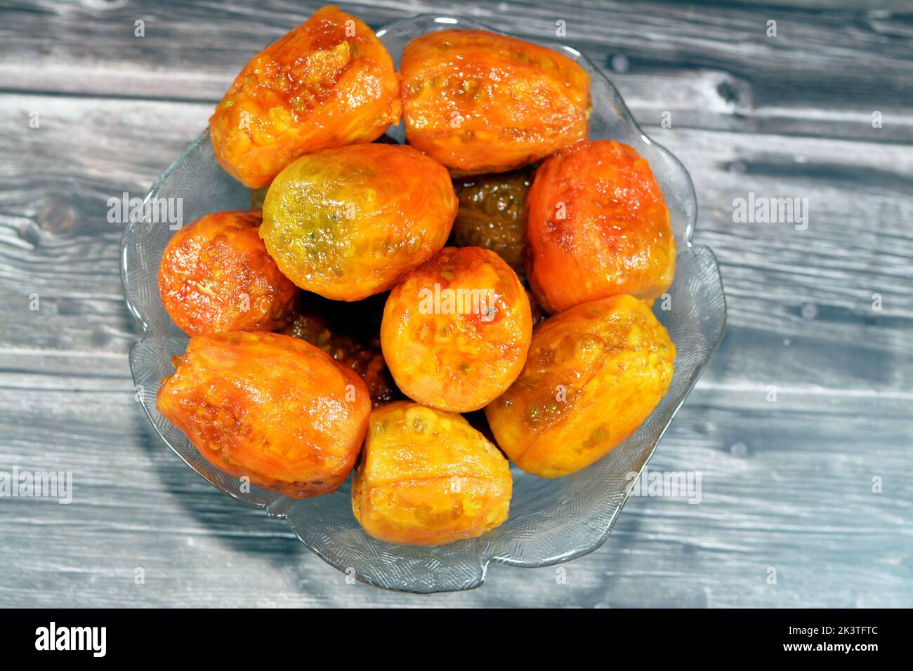 A pile of peeled fresh prickly pear fruit in a glass bowl isolated on ...