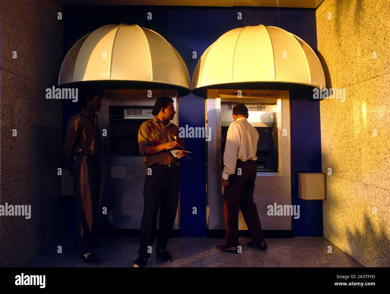 Dubai UAE Men Using Cash Machines outside Bank Stock Photo - Alamy